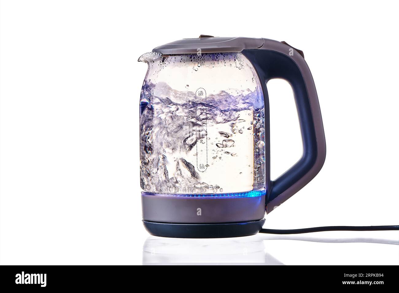 Glass electric kettle with boiling water on a white insulated ...