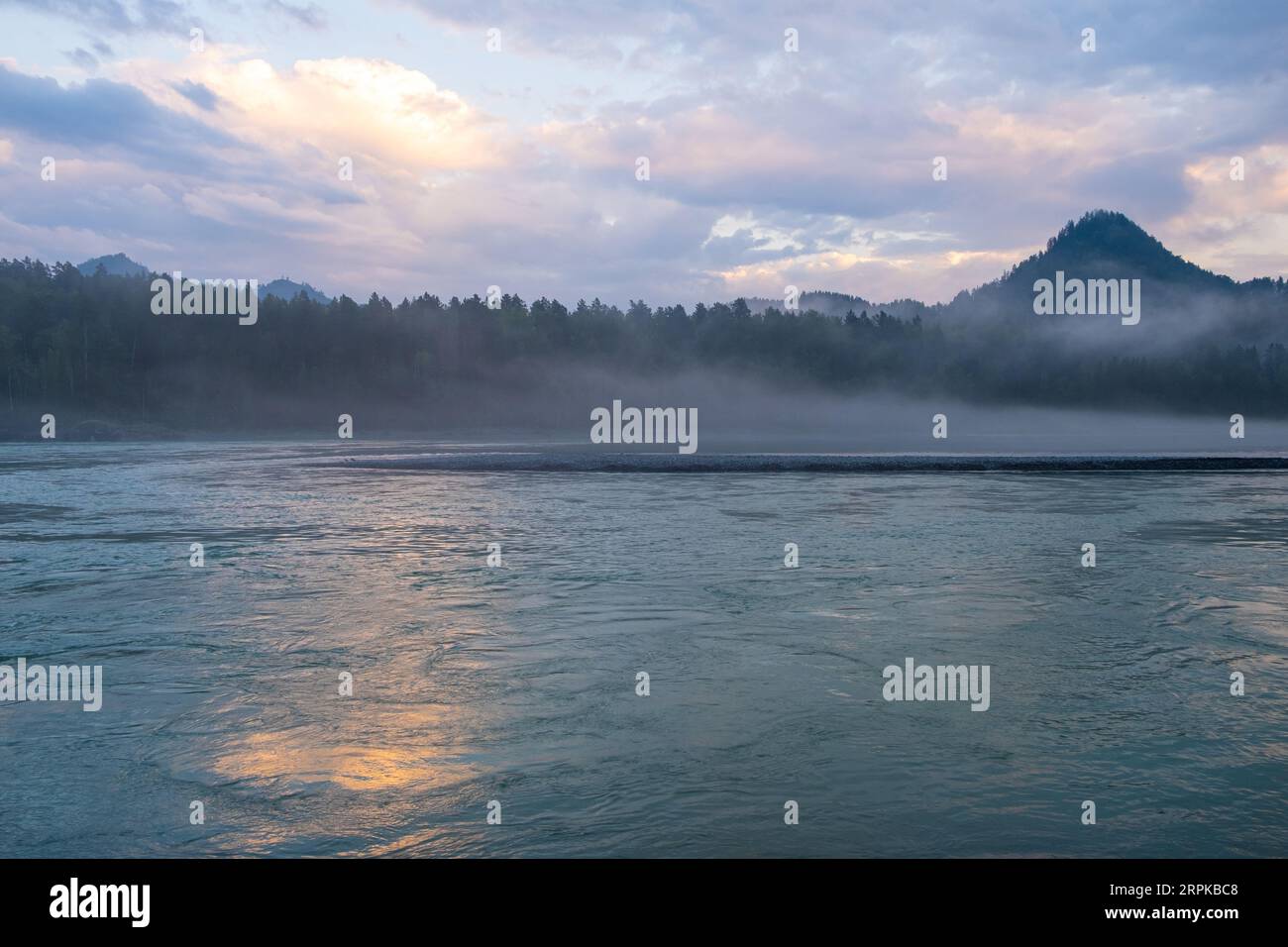 A wide, full-flowing mountain river with a fast current Stock Photo - Alamy
