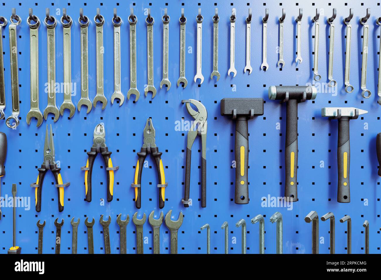 Garage tools hanging on the organizer wall. Wrenches, pliers ...