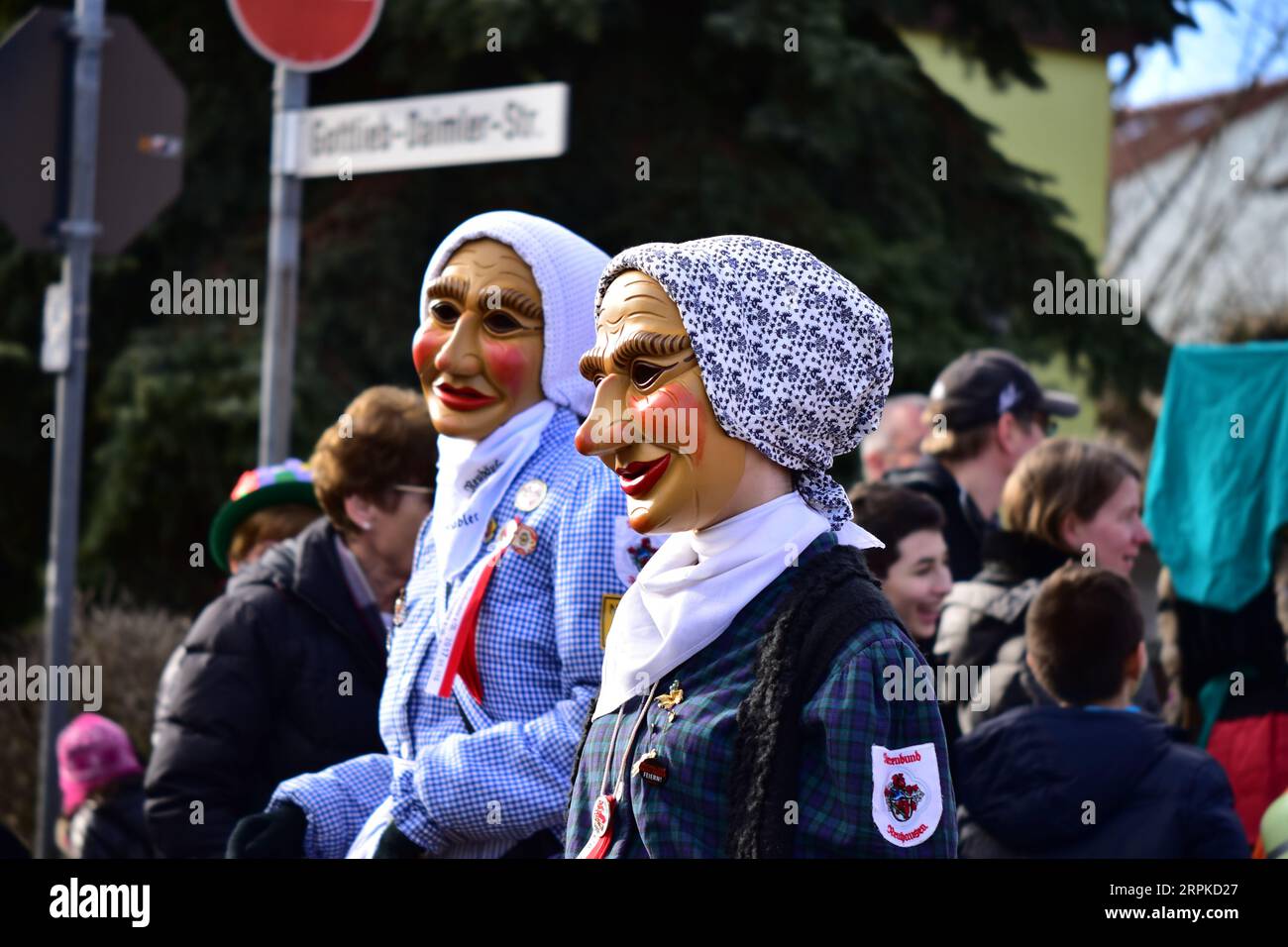 A group of people in festive masks participating in a traditional ...