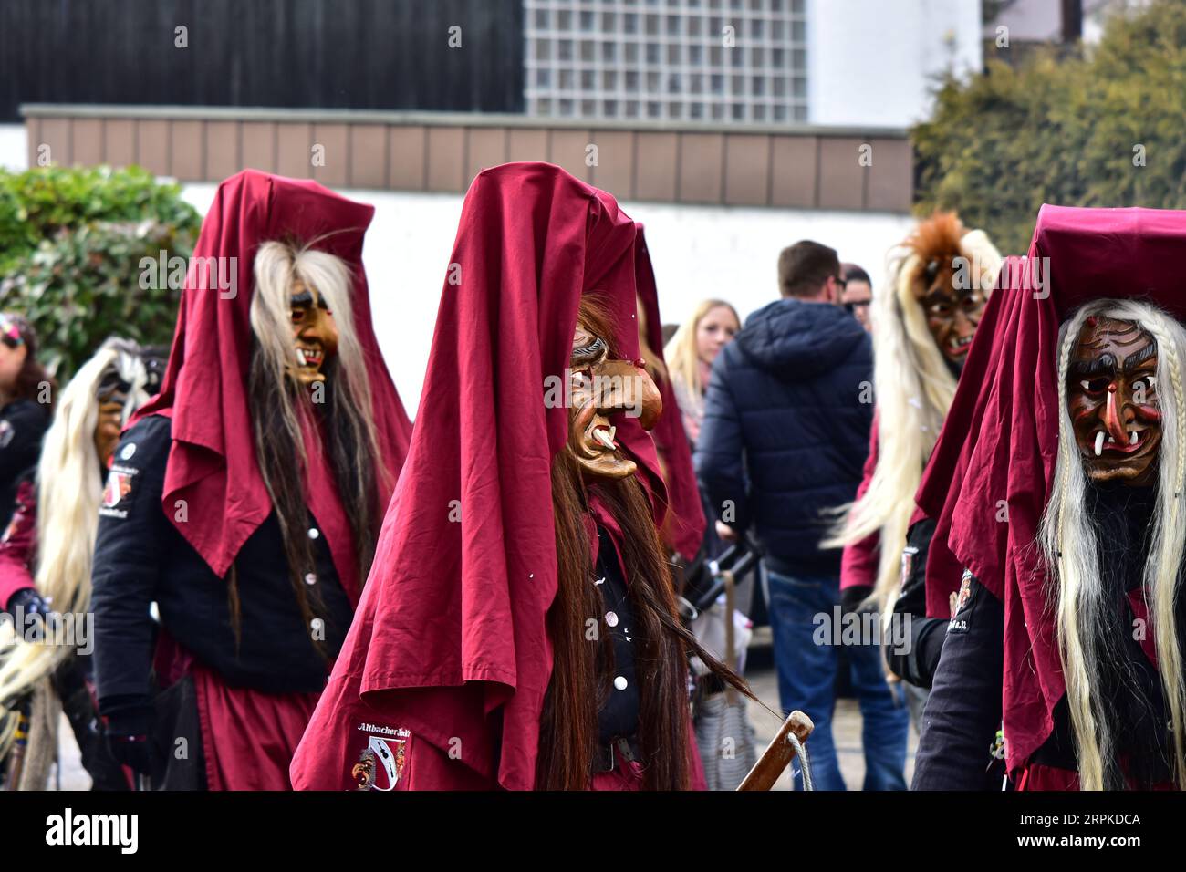 A group of people in festive masks participating in a traditional ...