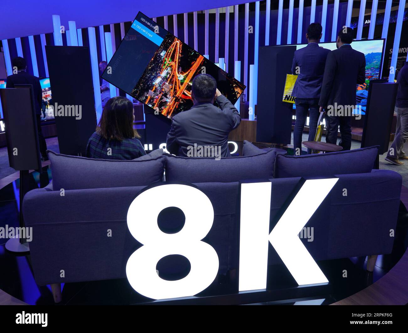 200109 -- LAS VEGAS, Jan. 9, 2020 -- Visitors watch Skyworth 8K TVs at the 2020 Consumer ...