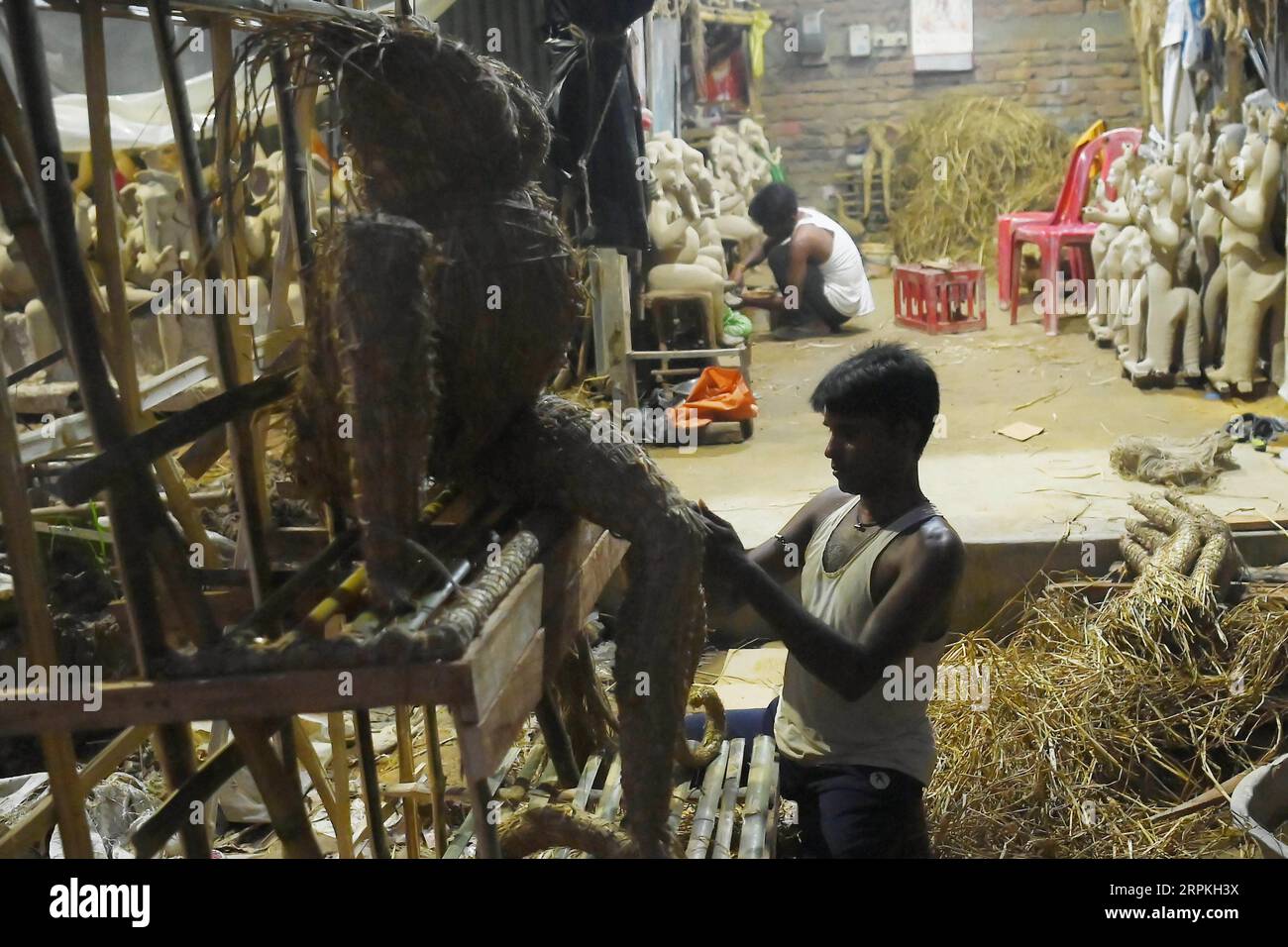 An Idol maker making idols of Lord Ganesh in a studio for the upcoming ...