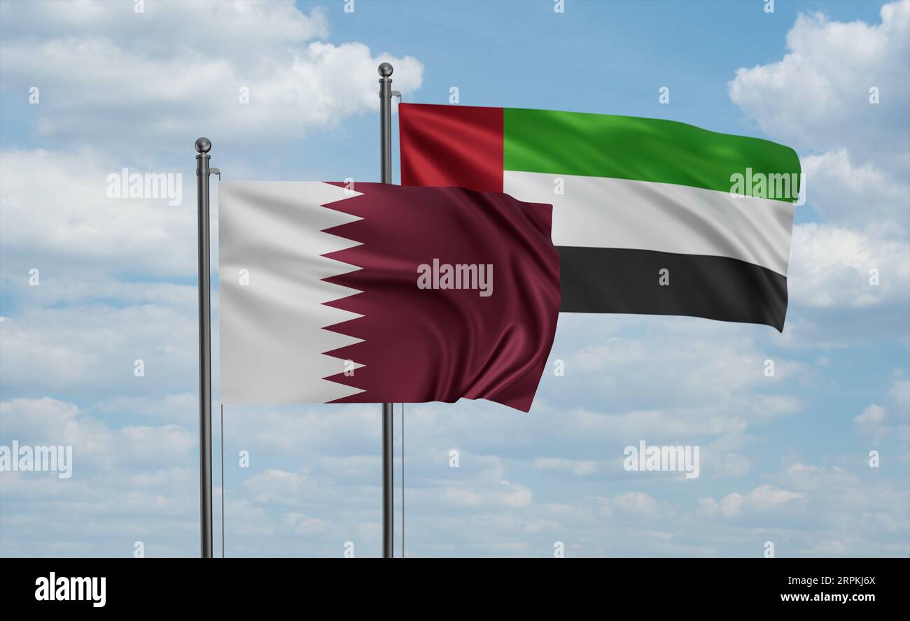 United Arab Emirates and Qatar flag waving together in the wind on blue ...