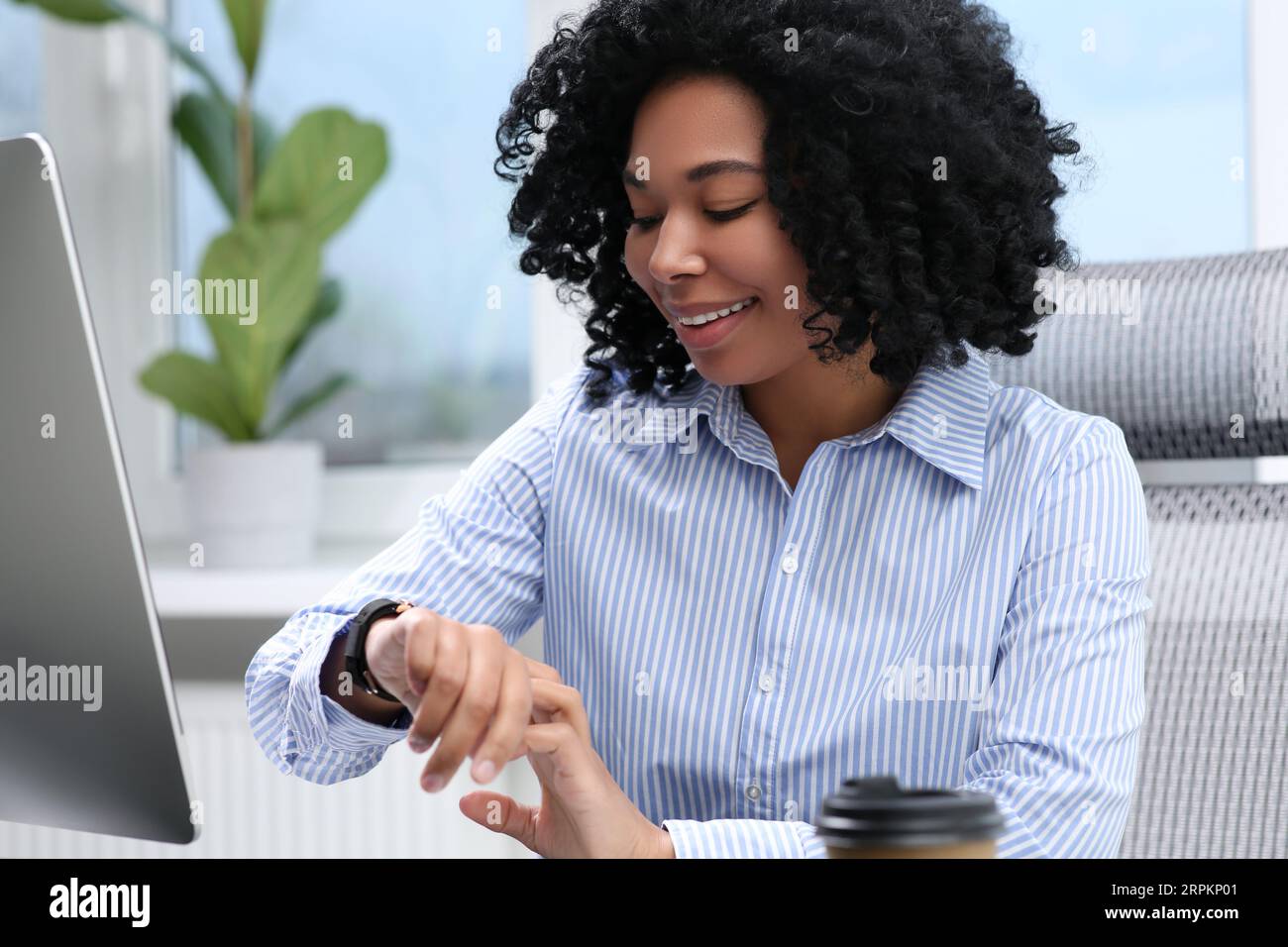 Busy woman checking watch and working hi-res stock photography and ...