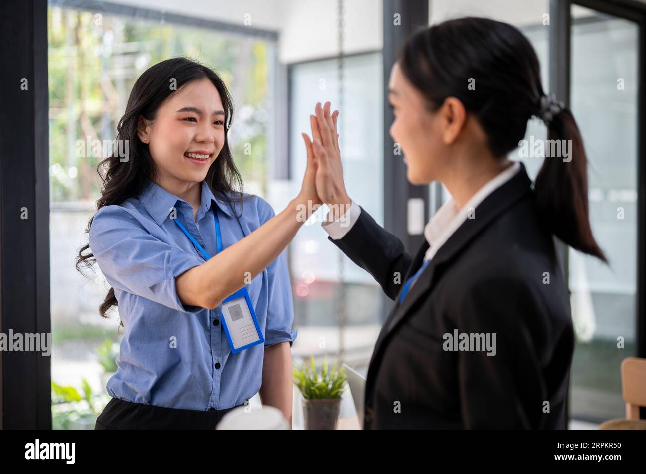 A beautiful and cheerful young Asian businesswoman or female office ...