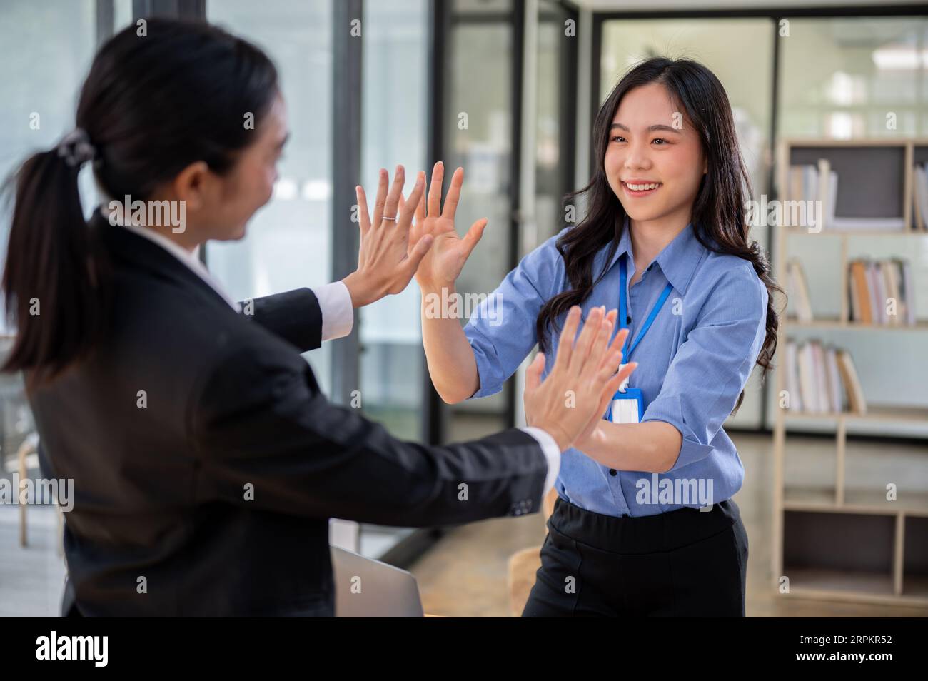 A beautiful and cheerful young Asian businesswoman or female office ...