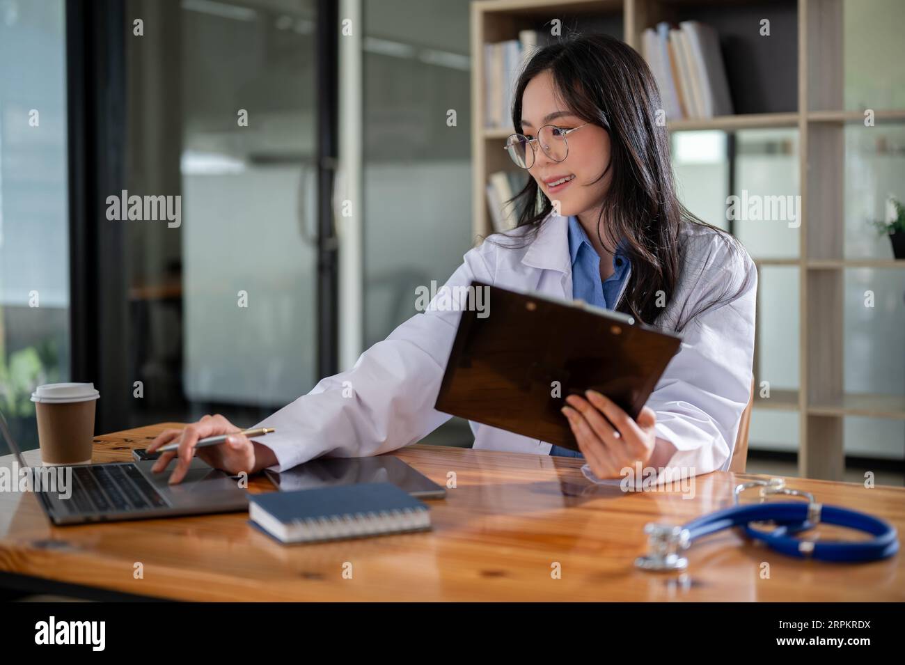 A professional and beautiful Asian female doctor is working on her ...