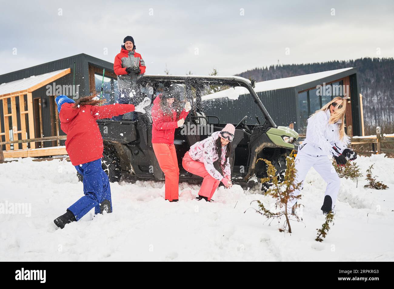Happy women having fun in snow. Off-road buggy car on background ...
