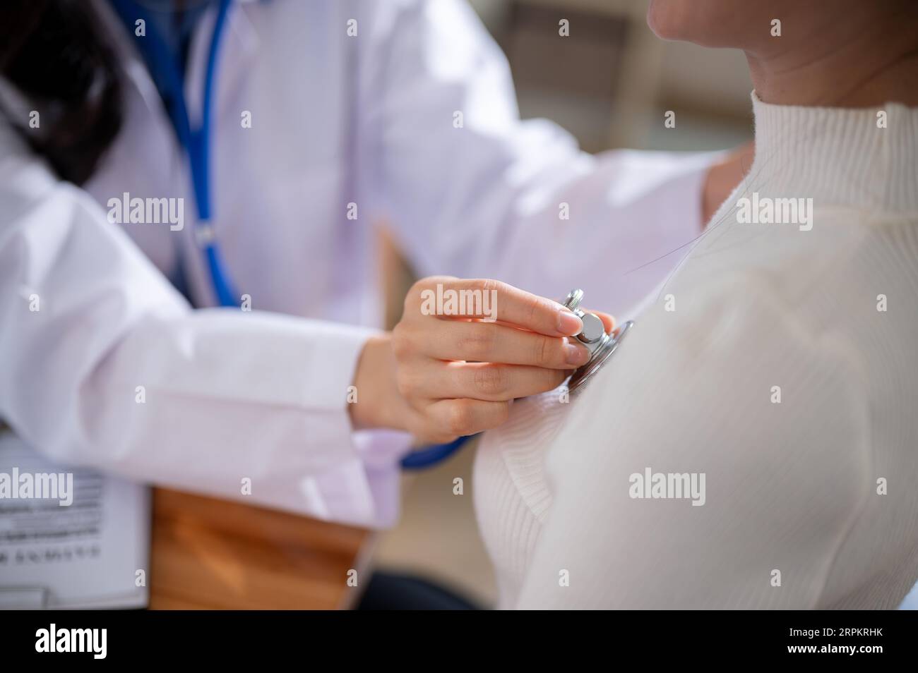 Doctor listening patients chest stethoscope hi-res stock photography ...