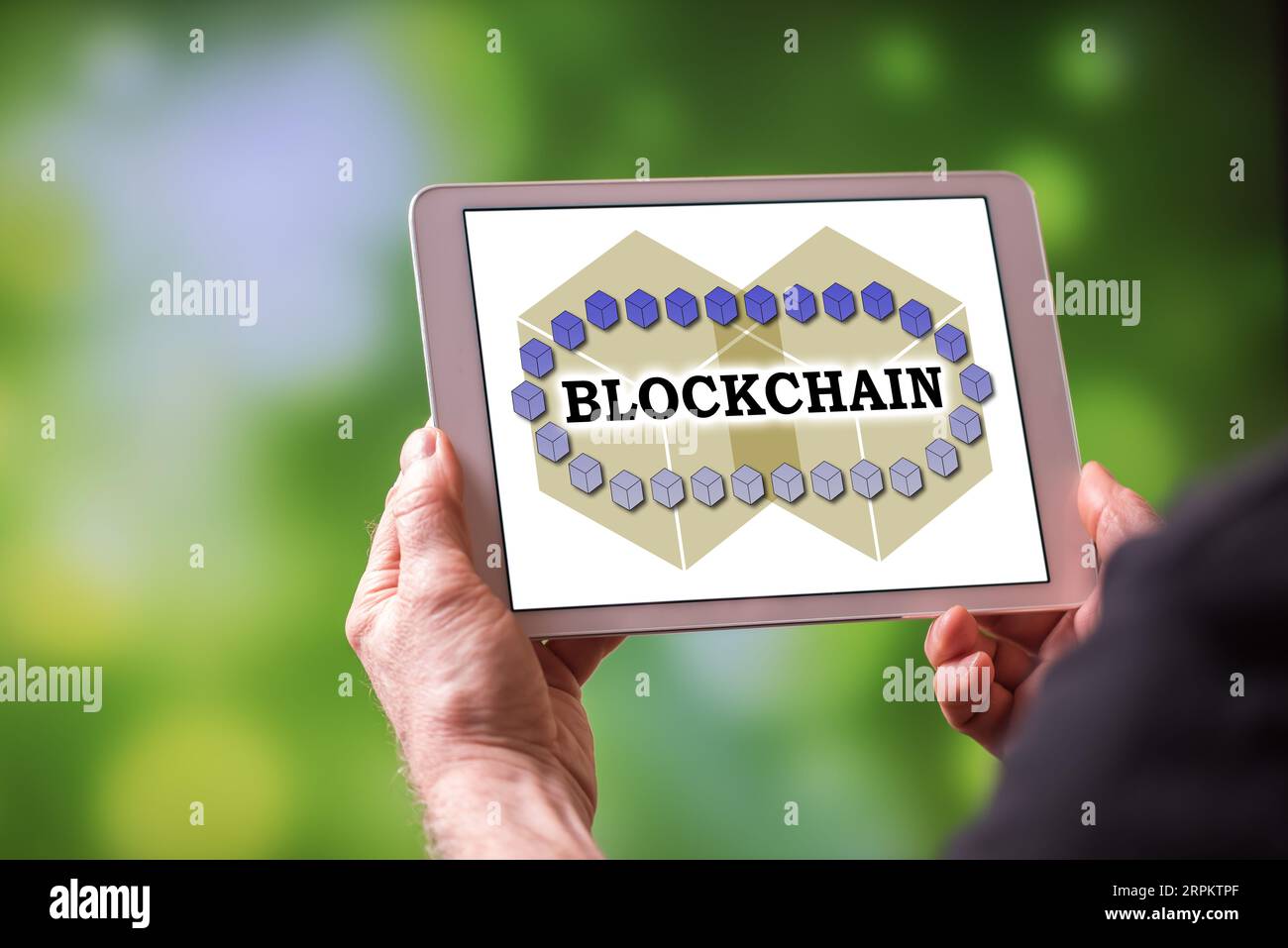 Man holding a tablet showing blockchain technology concept Stock Photo ...