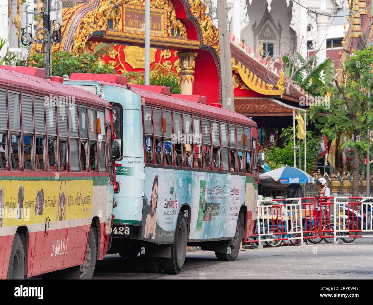 City buses waiting outside the gate of Wat Hua Lam Phong, a Buddhist ...