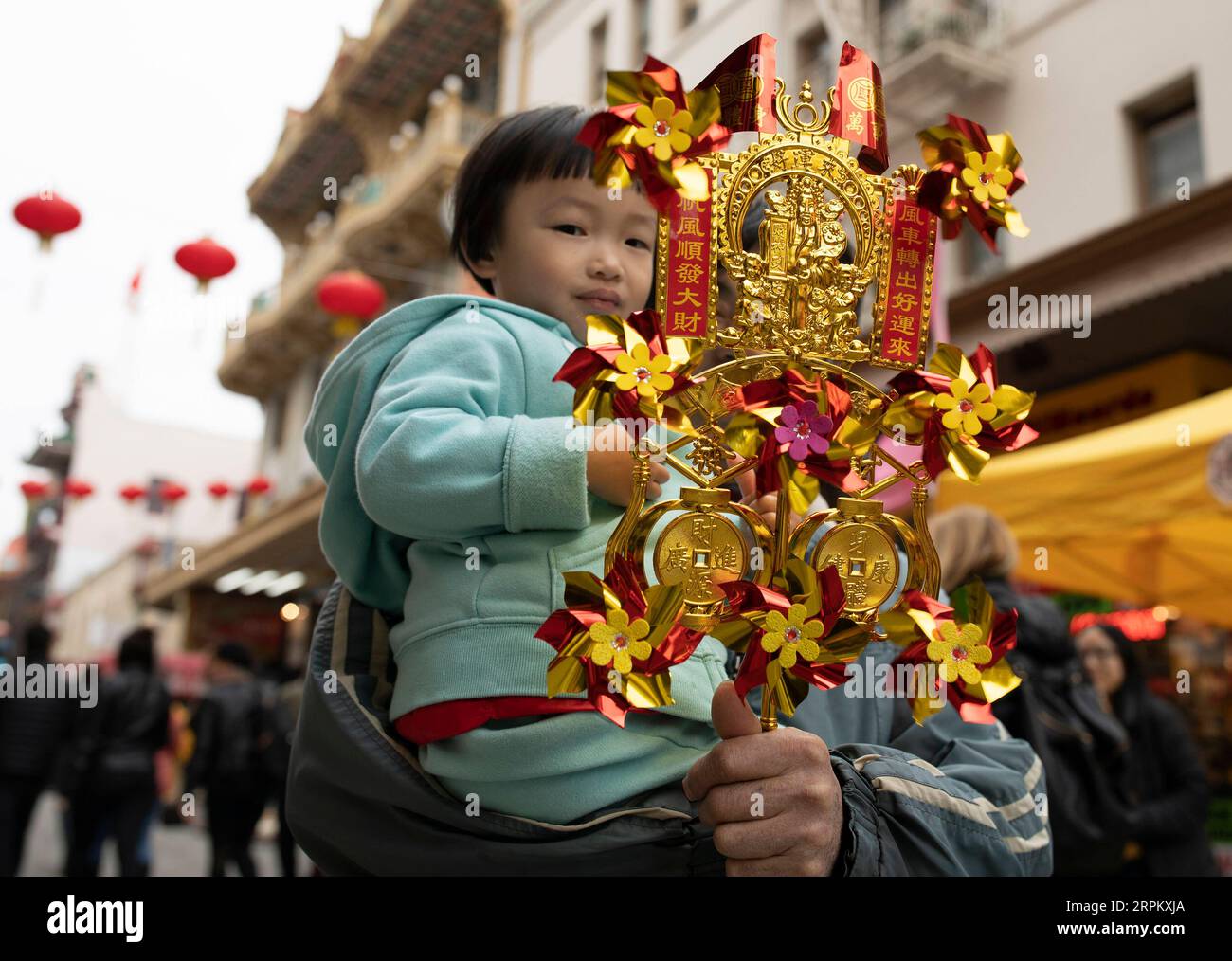 200120 -- SAN FRANCISCO, Jan. 20, 2020 -- A girl stares at a good-luck ...