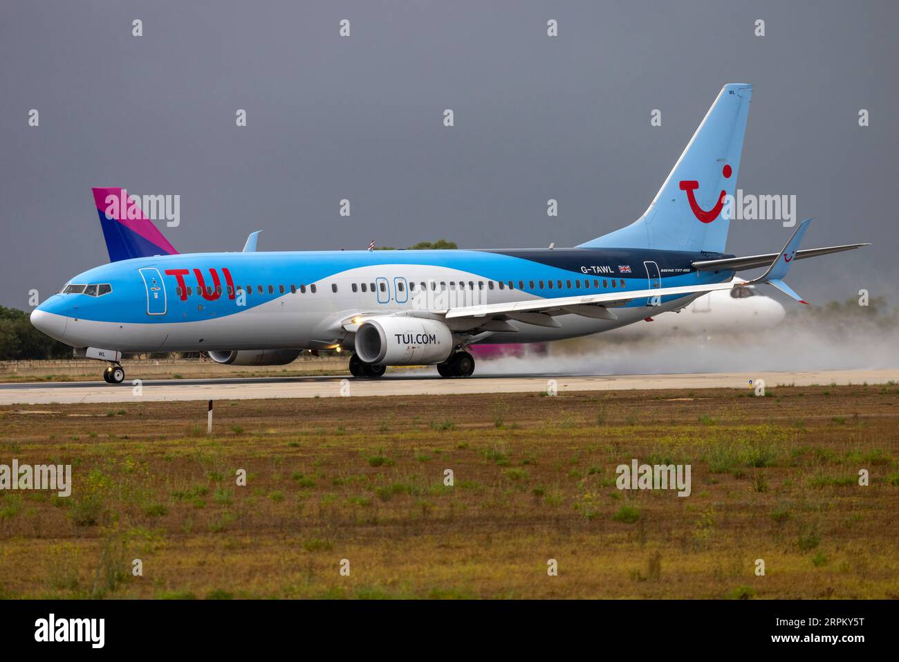 TUI Airways Boeing 737-8K5 (REG: G-TAWL) taking off after a shower ...