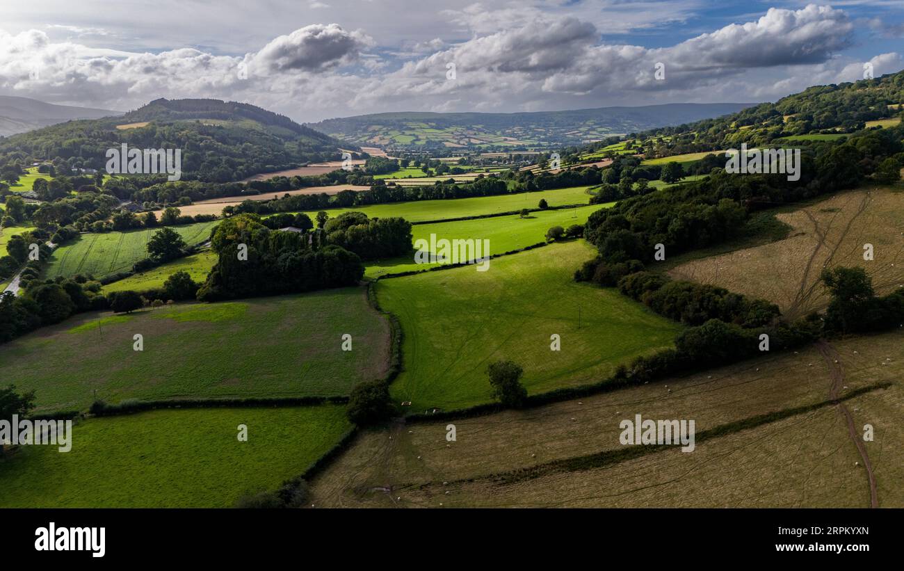 An aerial view of the Welsh countryside with mountains in the distance ...