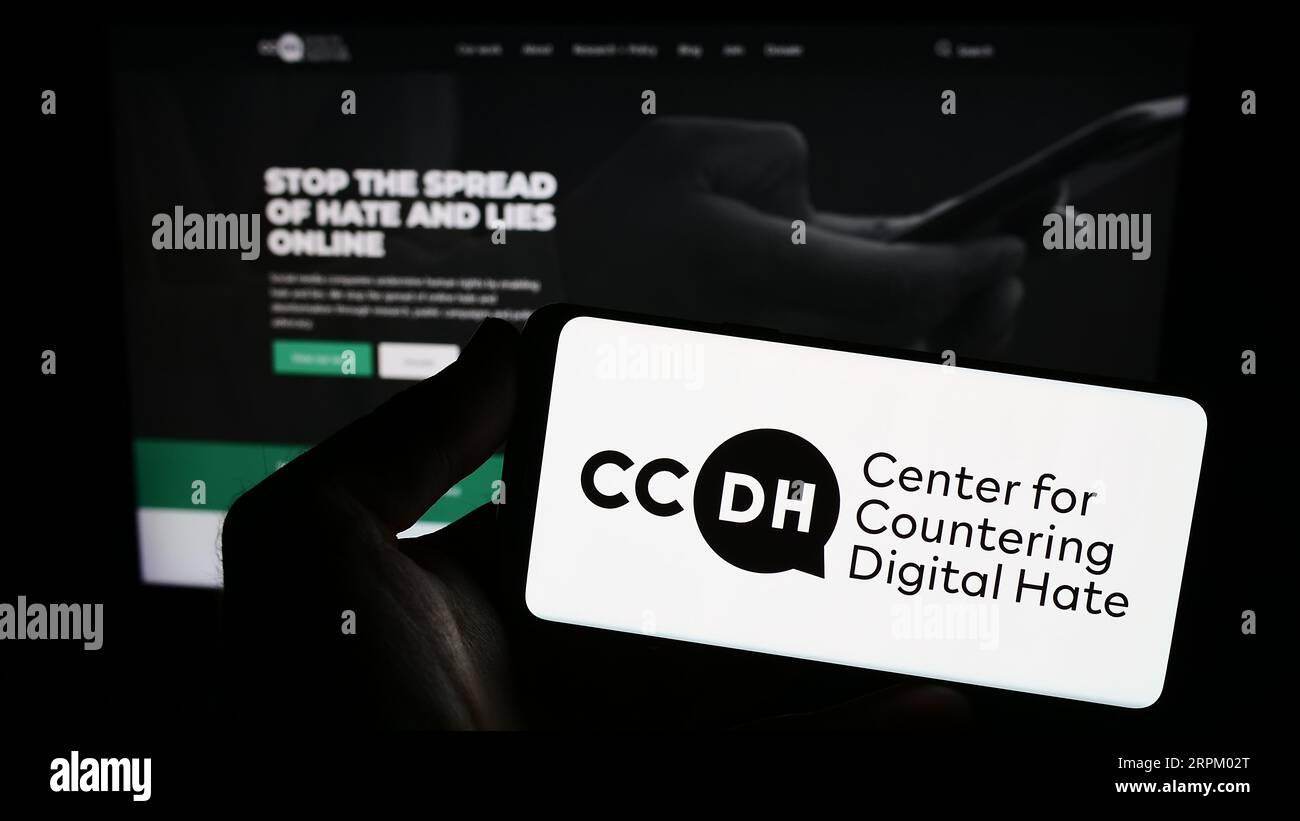 Person holding smartphone with logo of Center for Countering Digital ...