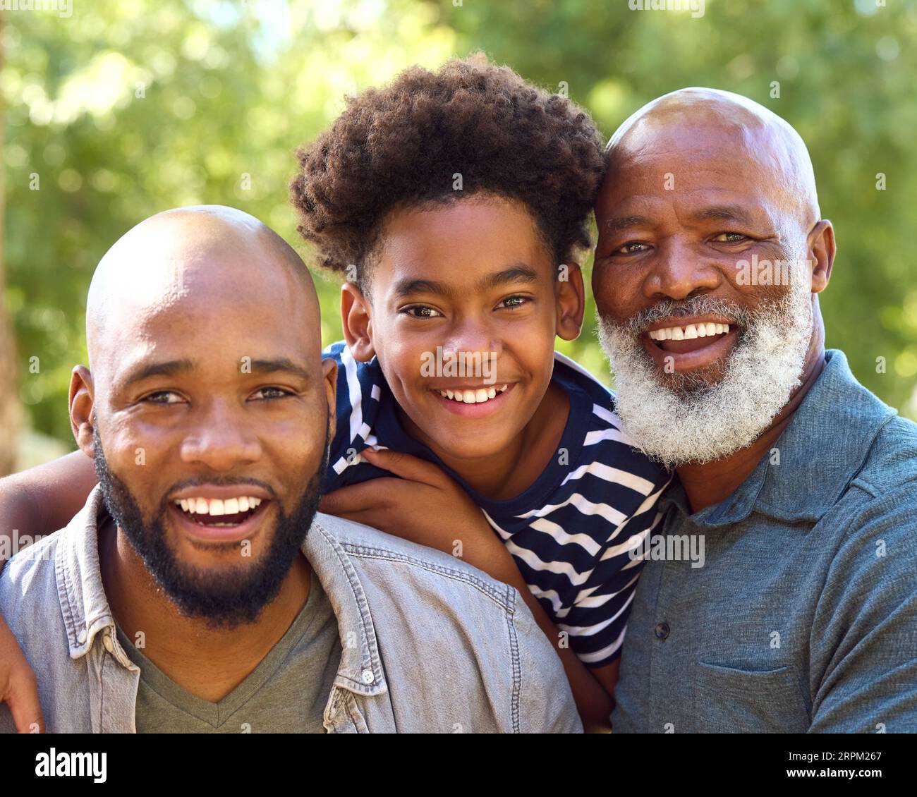 Portrait Of Multi-Generation Male Family Having Fun Playing Outdoors In ...