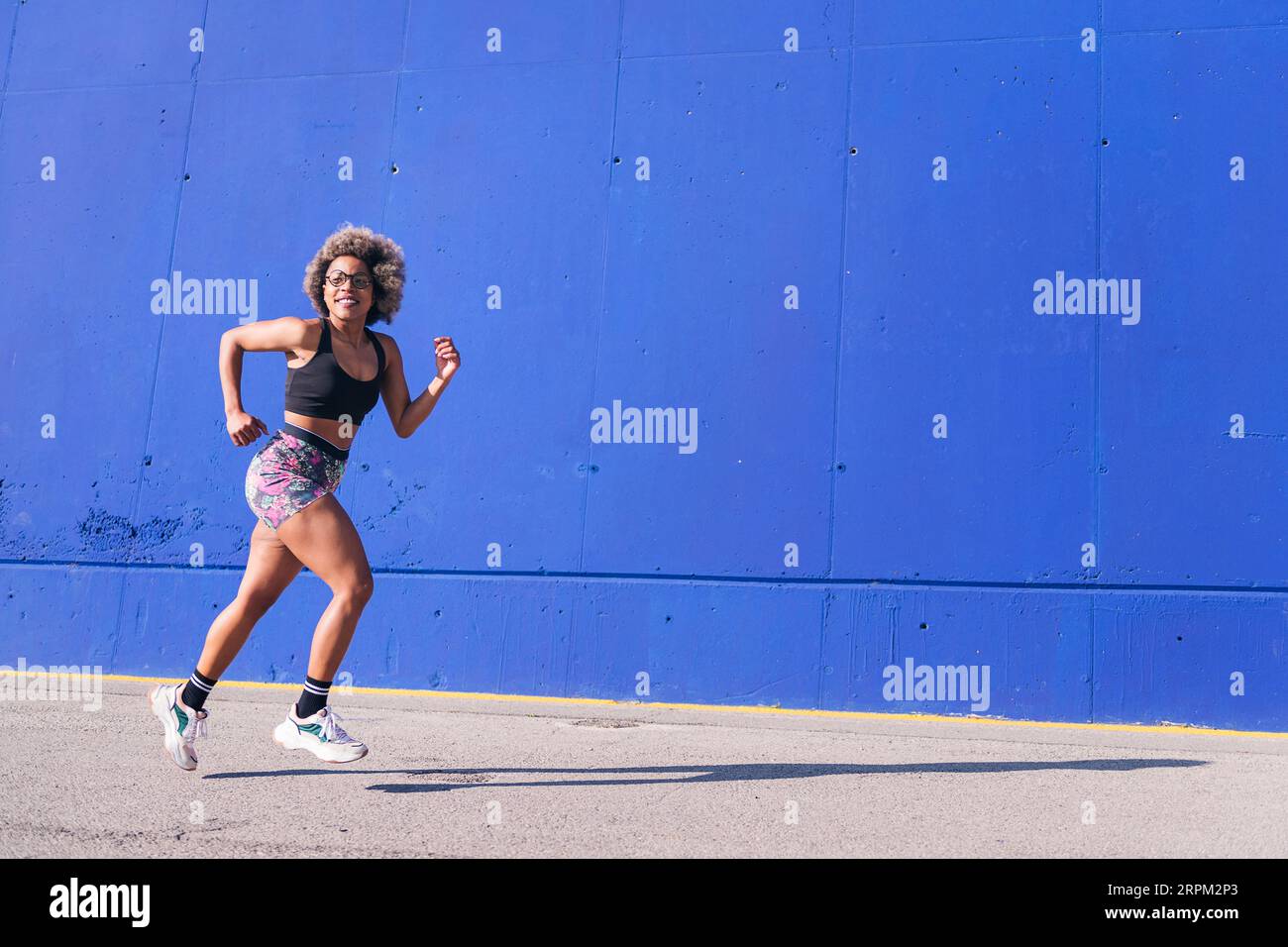african woman running in an urban track Stock Photo - Alamy