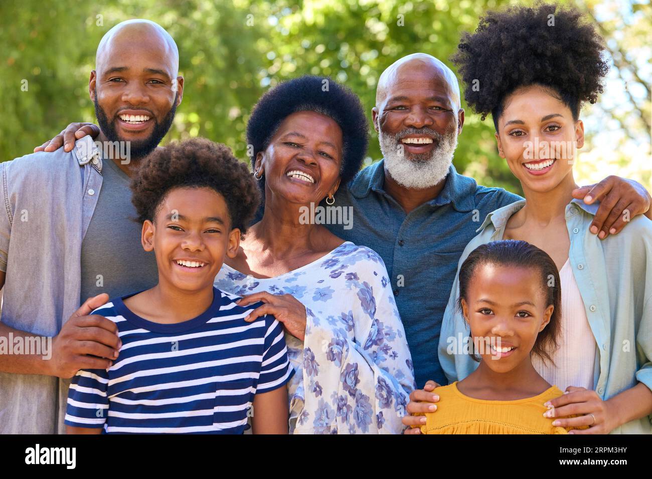 Portrait Of Multi-Generation Family Standing Outdoors In Garden Or ...