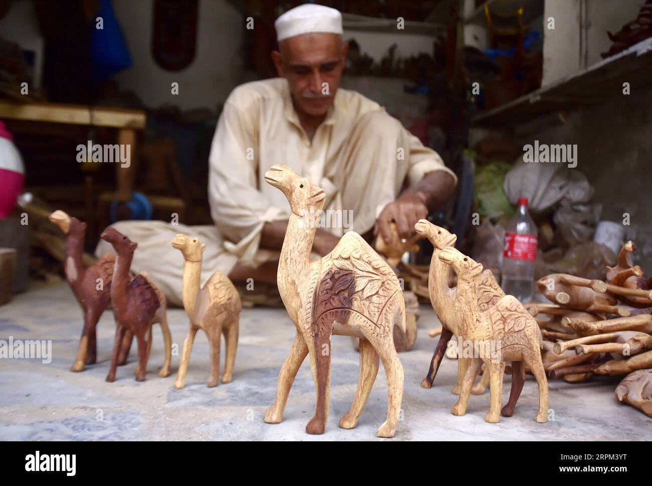 Peshawar, Pakistan. 4th Sep, 2023. An artisan makes wooden handicrafts ...