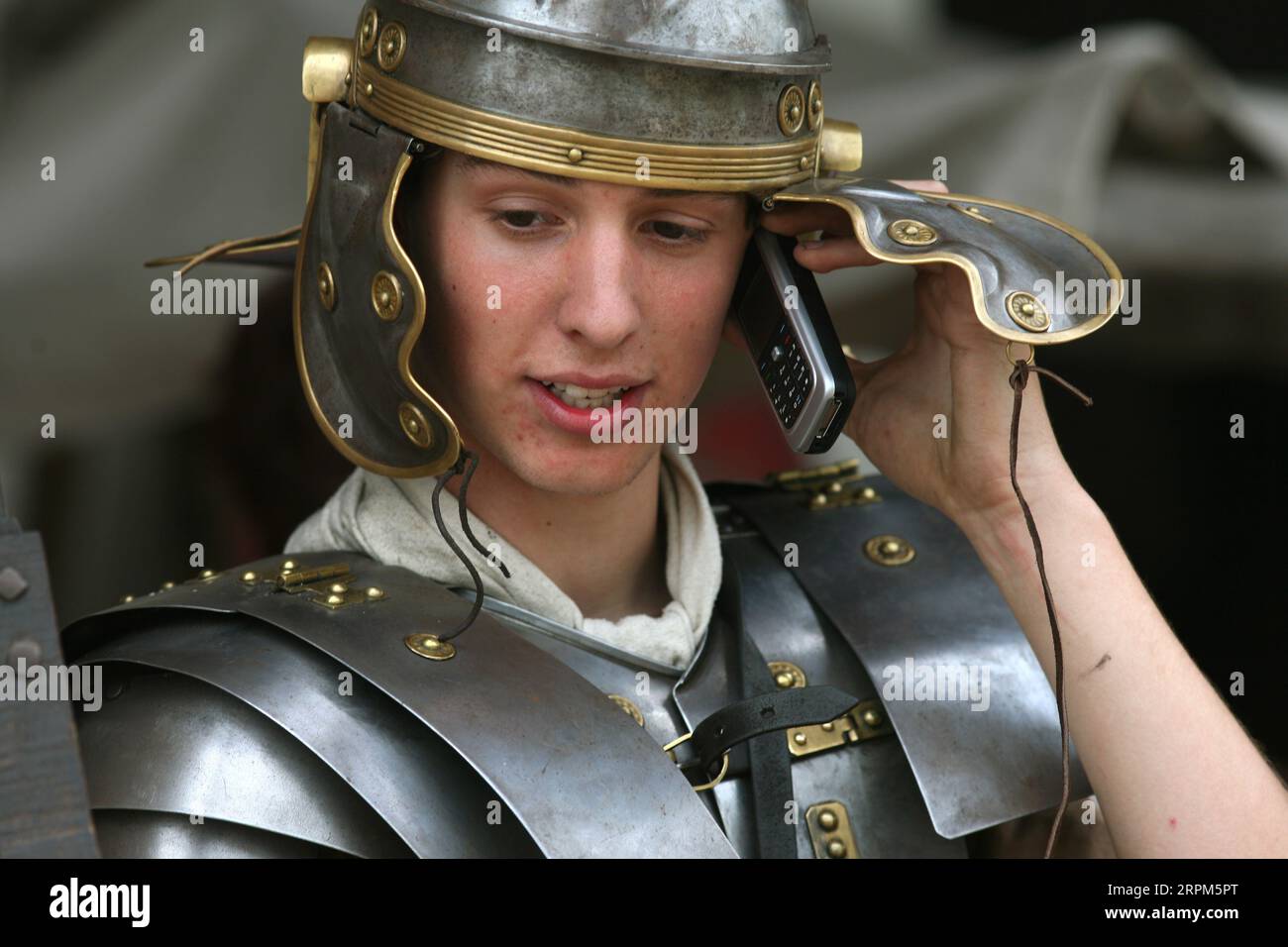 Netherlands, Actor in Roman armour suit making a phone call in ...