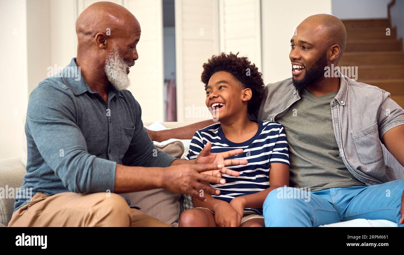Laughing Multi-Generation Male Family Hanging Out On Sofa At Home ...