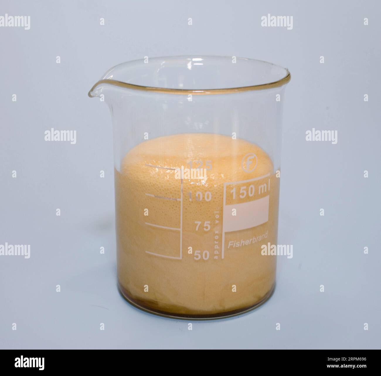 two liquid polymers in measuring cups added together gives chemical a ...