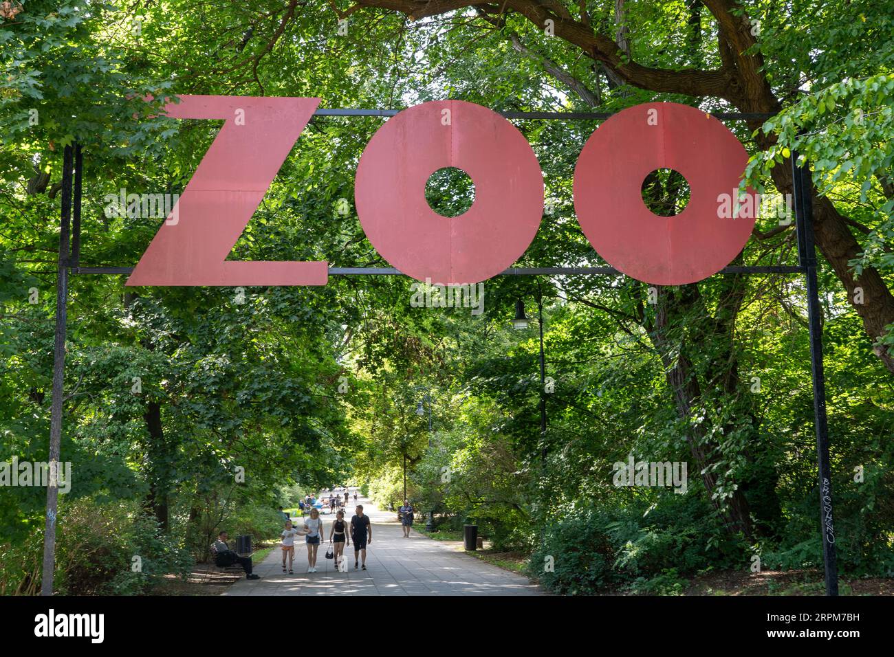 ZOO Polish. Word signboard. Sign entrance. Alley in a green park among ...