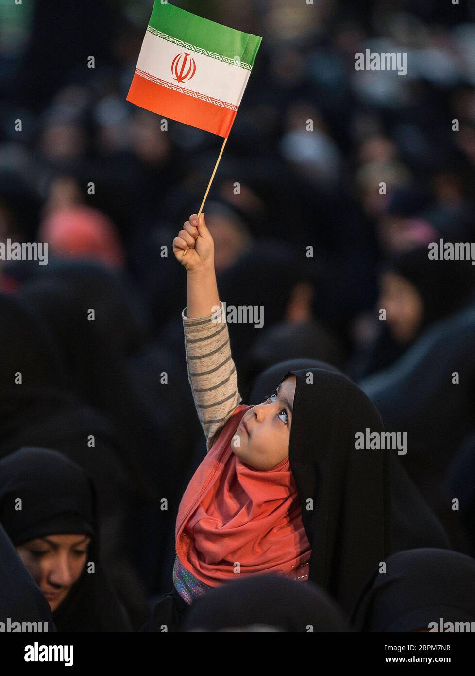 200201 -- TEHRAN, Feb. 1, 2020 -- A girl holds a national flag of Iran ...