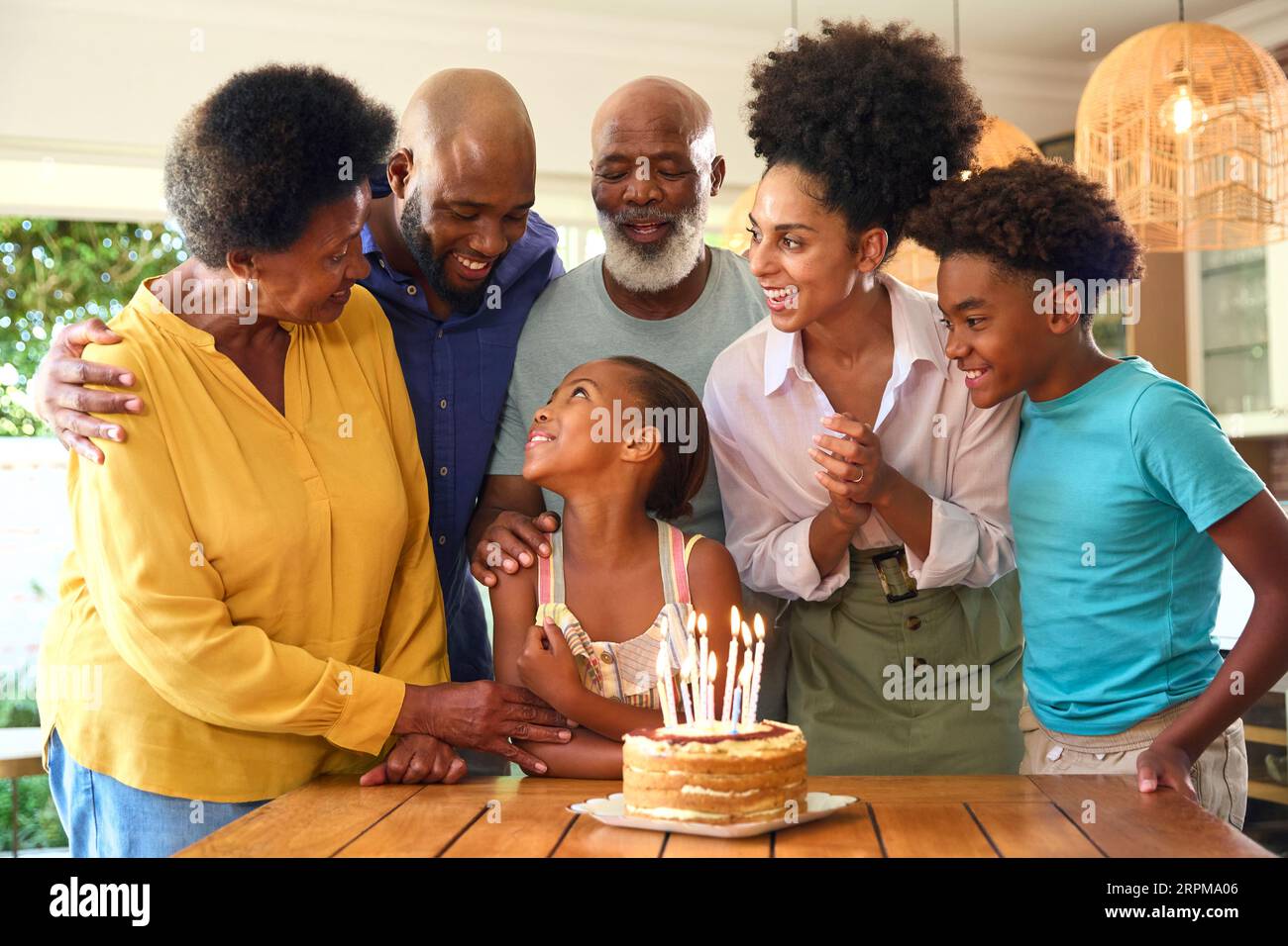 Multi-Generation Family Celebrating Granddaughter's Birthday With Cake ...