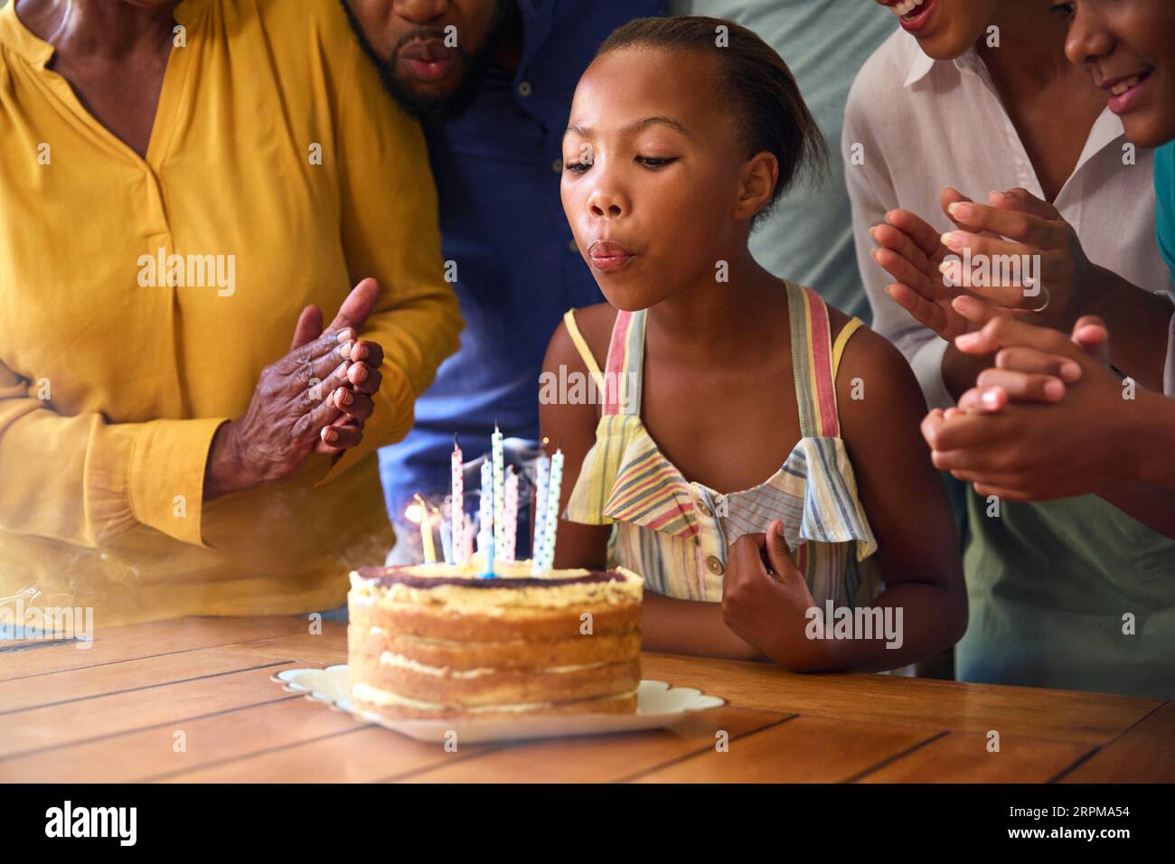 Multi-Generation Family Celebrating Granddaughter's Birthday With Cake ...