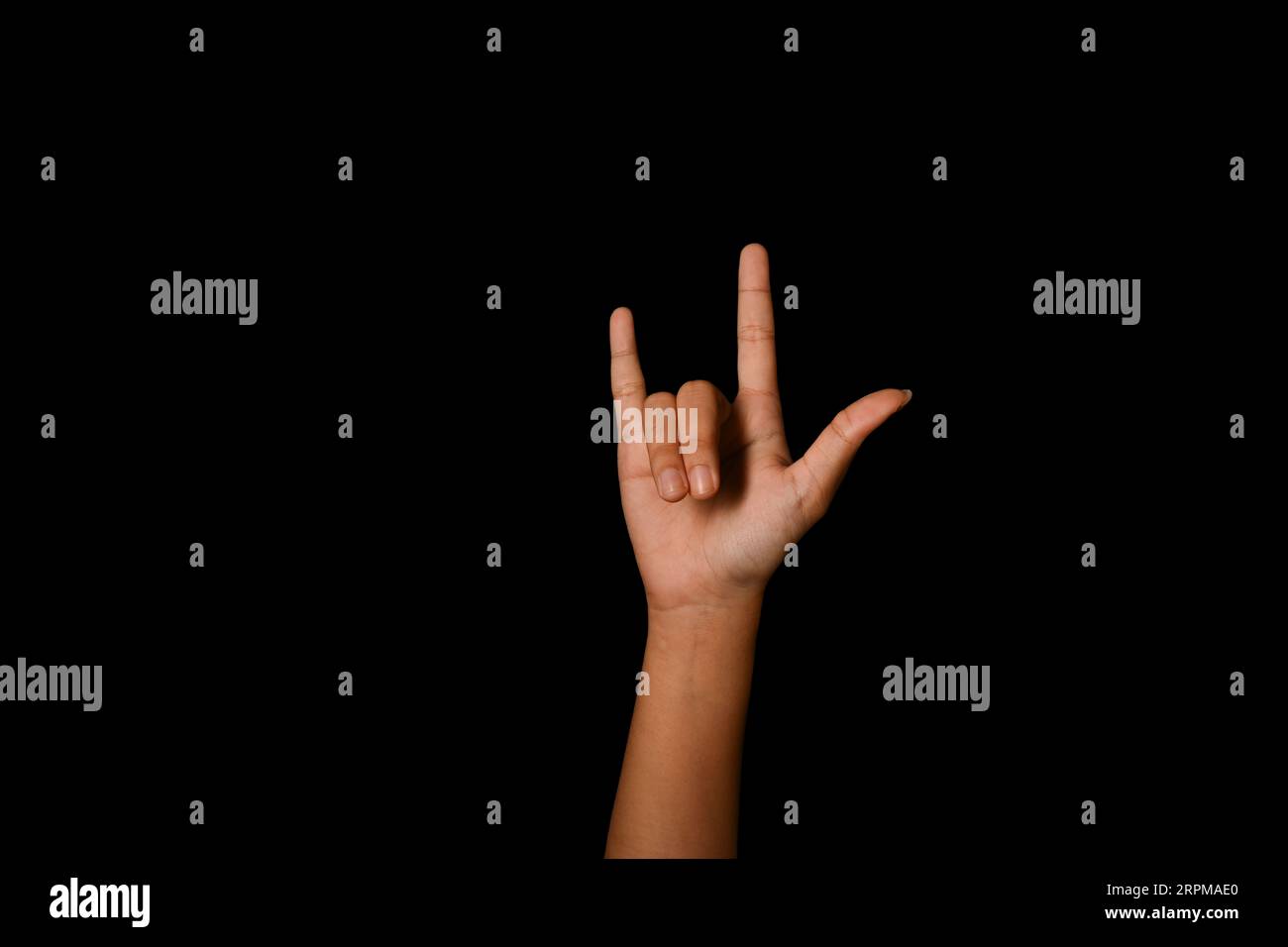 Hand showing I LOVE YOU in American sign language on black background ...