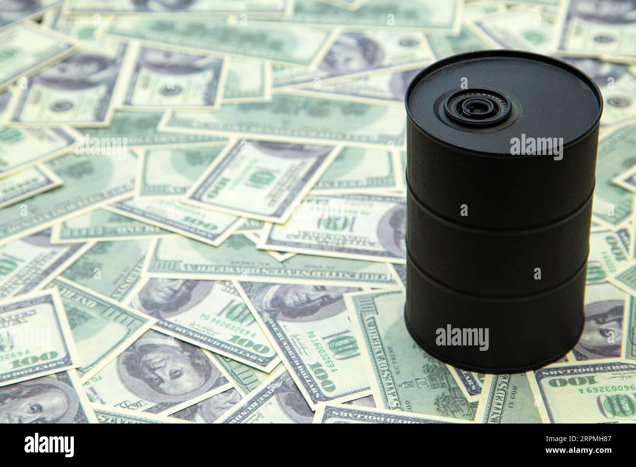 Barrel of oil on hundred dollar bills. The concept of oil, petrodollar ...