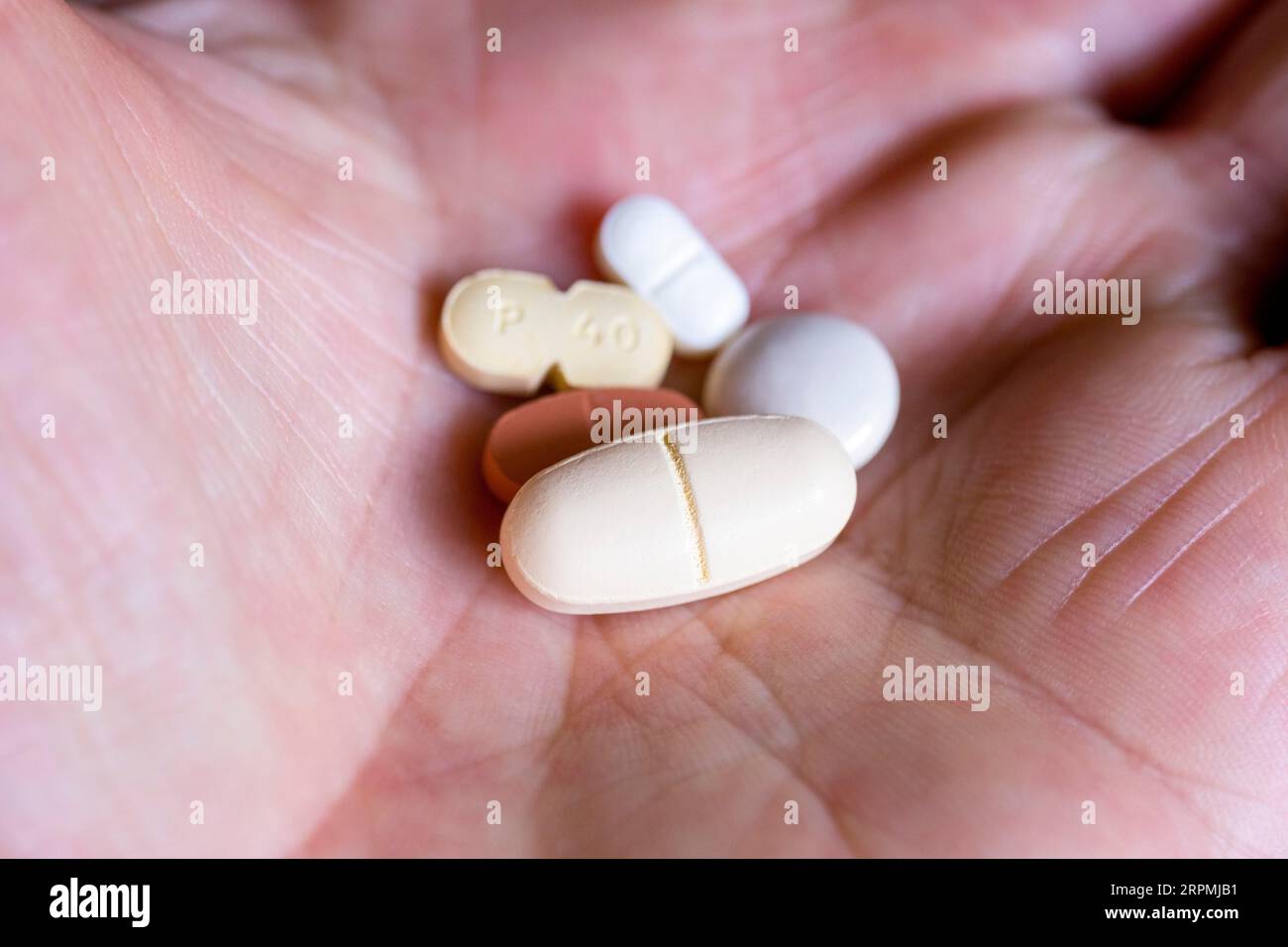Hand holds various tablets, medicines Stock Photo - Alamy