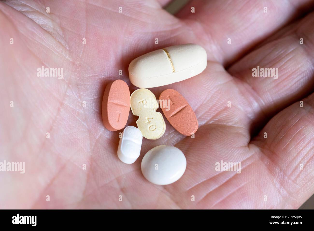 Hand holds various tablets, medicines Stock Photo - Alamy