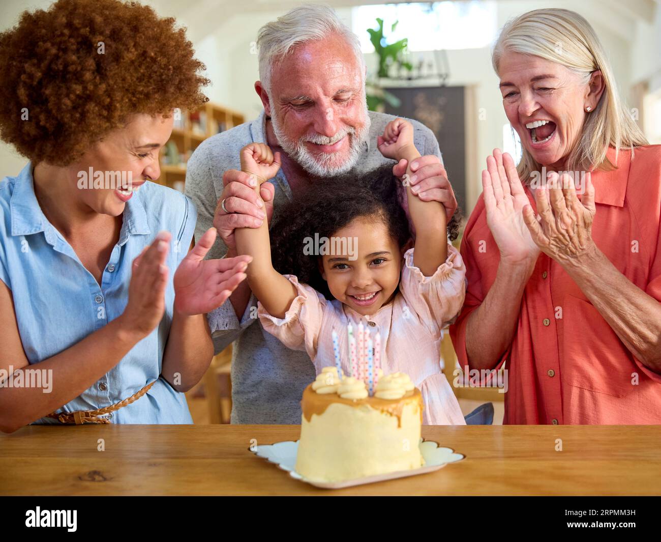 Multi-Generation Family Celebrating Granddaughter's Birthday At Home ...