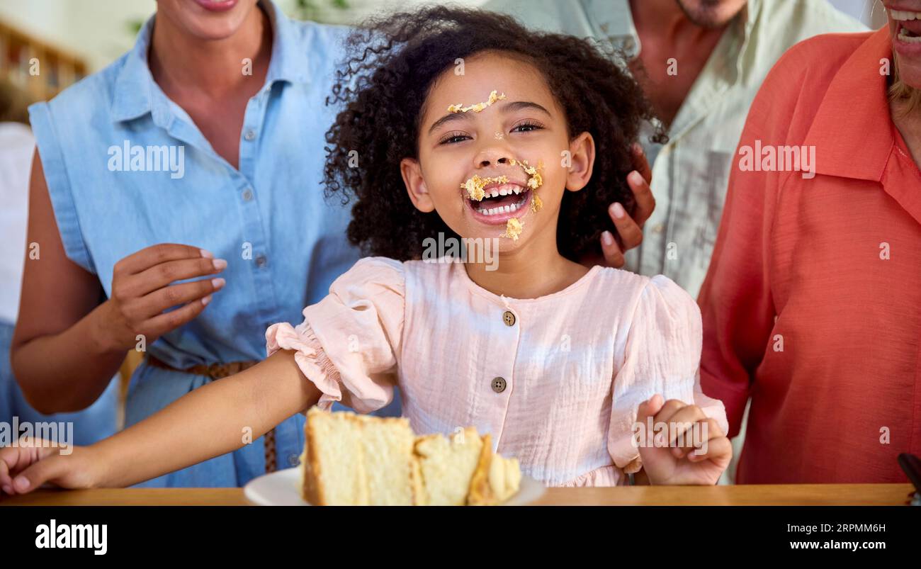 Granddaughter Making Mess With Cake As Multi-Generation Family ...