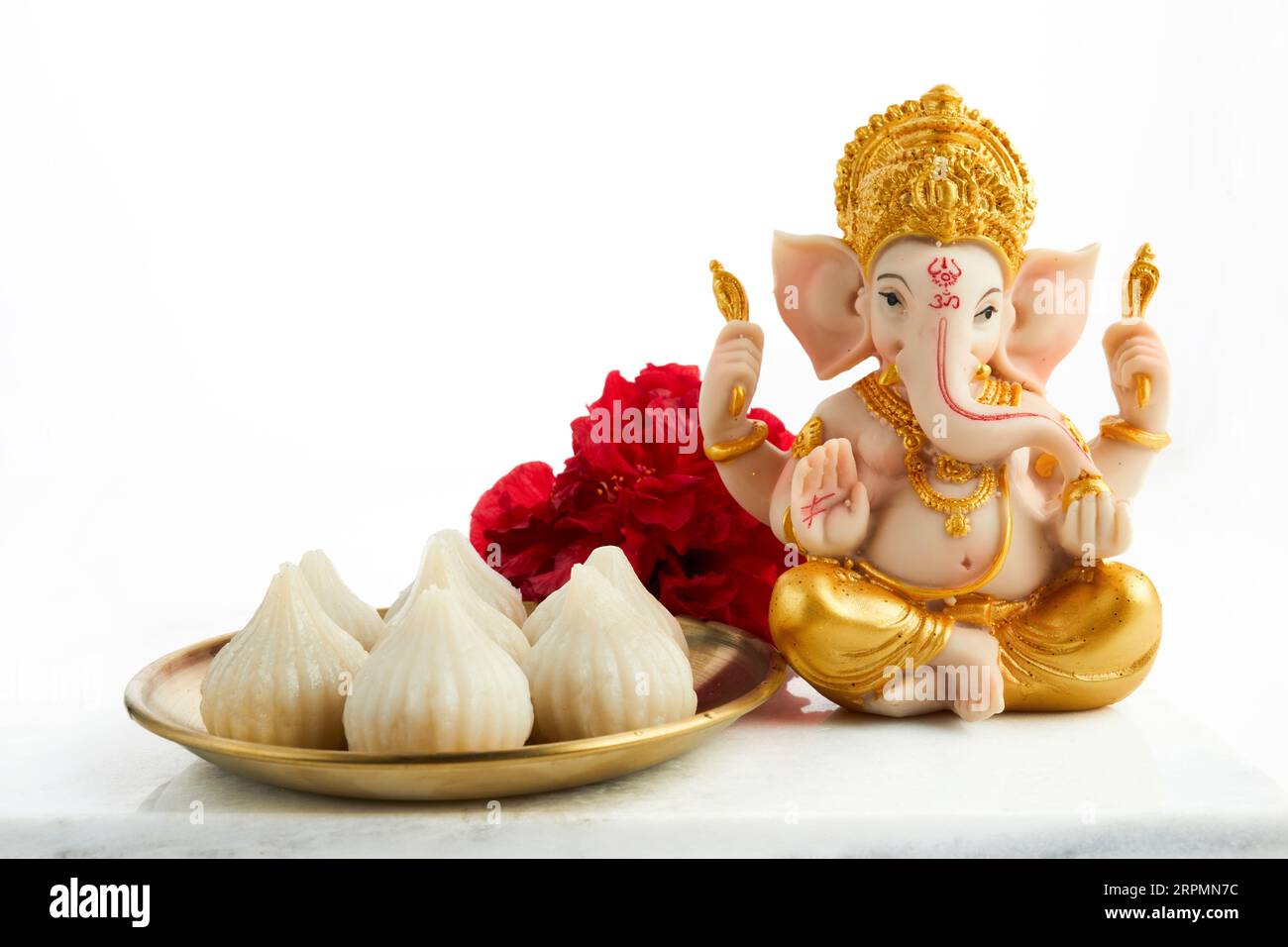 Idol of lord Ganesha with Modak Sweet Dish and flower. Ganesh chaturthi ...