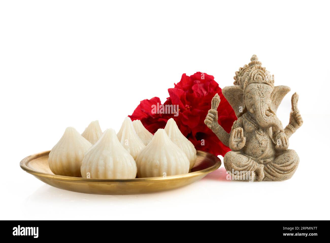 Idol of lord Ganesha with Modak Sweet Dish and flower. Ganesh chaturthi ...