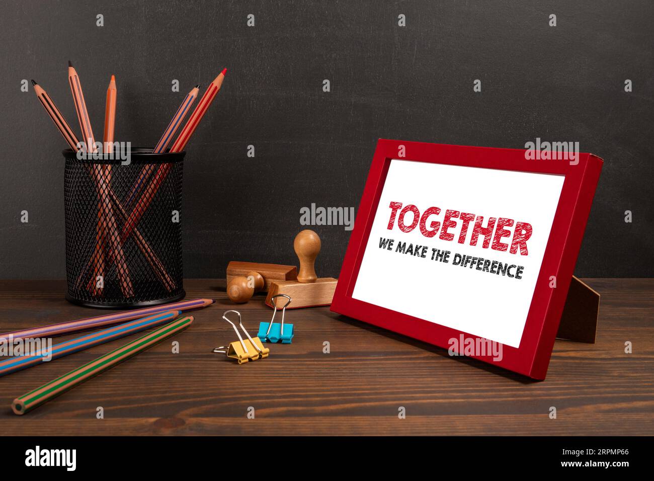 TOGETHER WE MAKE THE DIFFERENCE. A picture frame on the office table ...