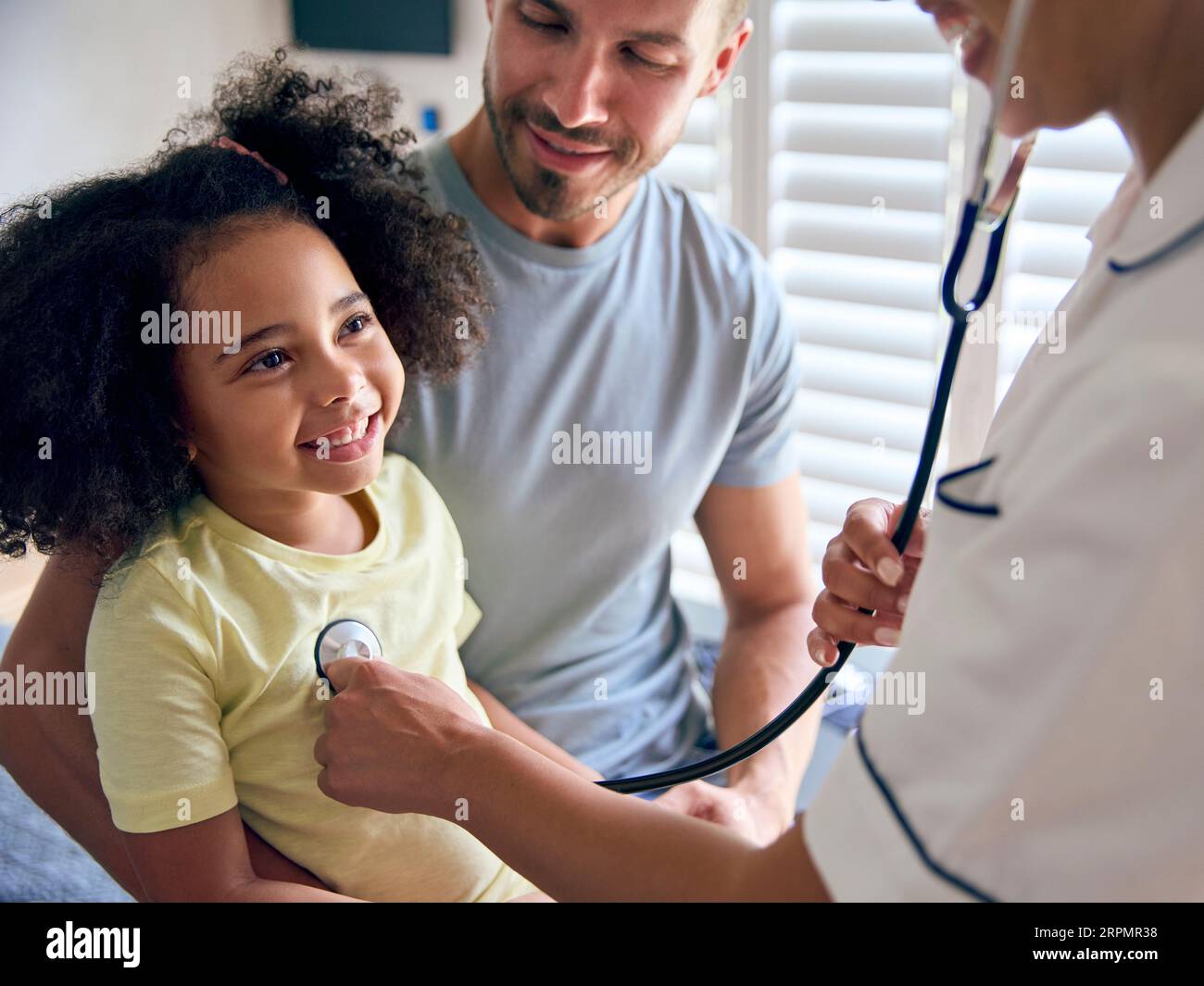 Nurse Wearing Uniform Listening To Girl Patient's Chest With ...