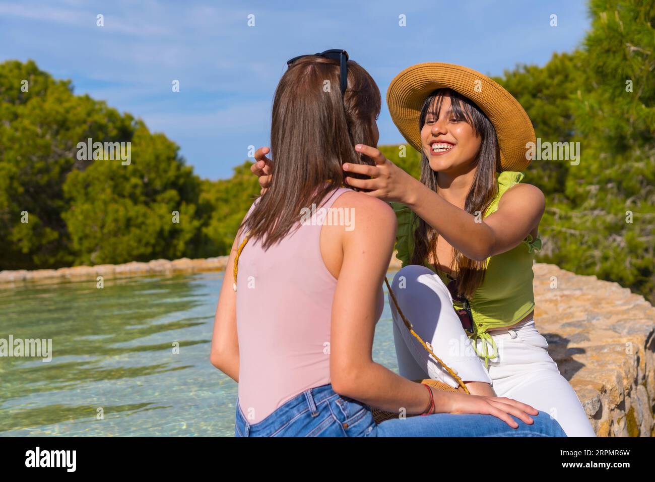 Female friends having fun on vacation in a park in summer, sitting ...