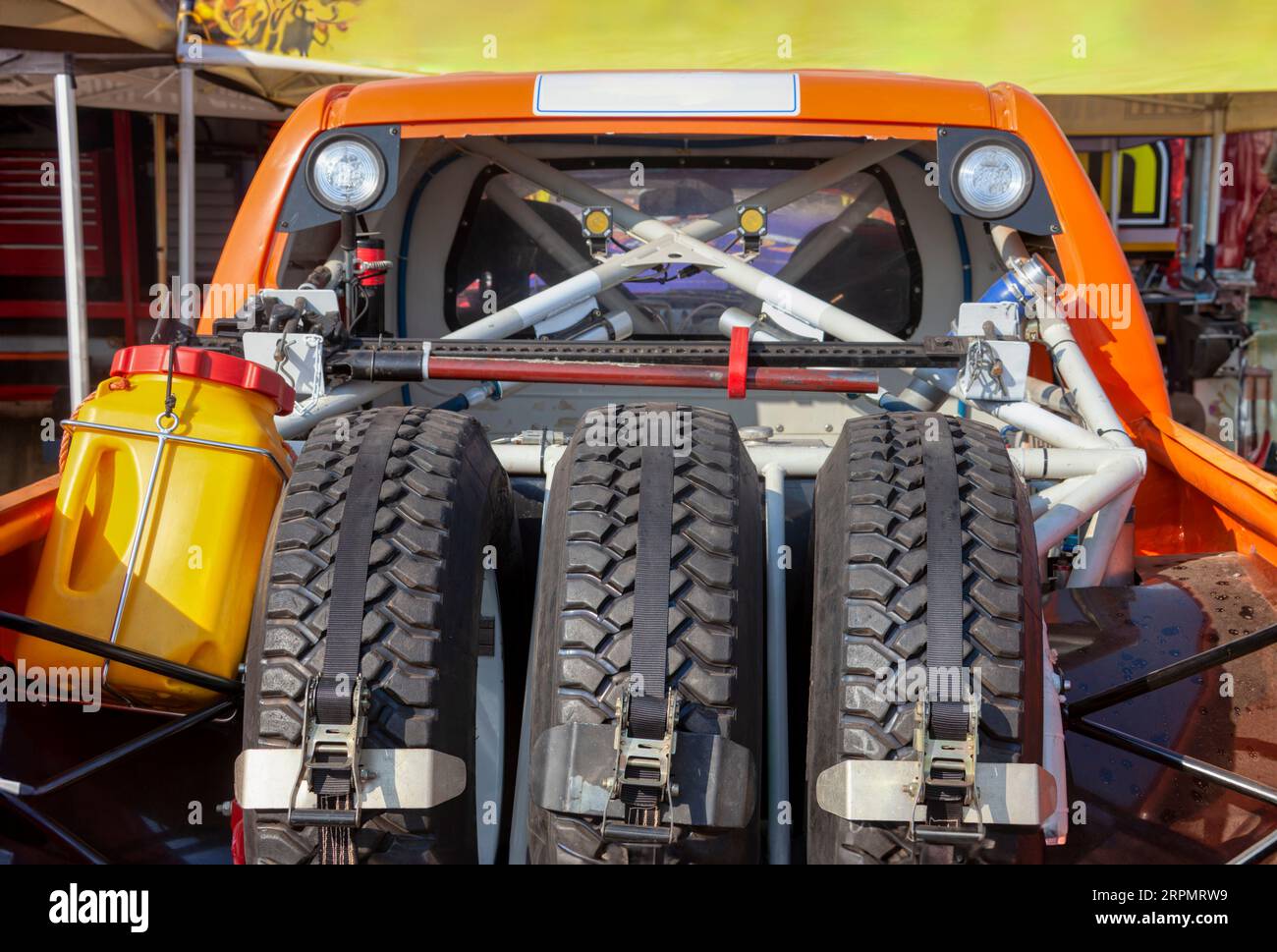 4x4 offroad race vehicle, few new tires strapped in the back and ...