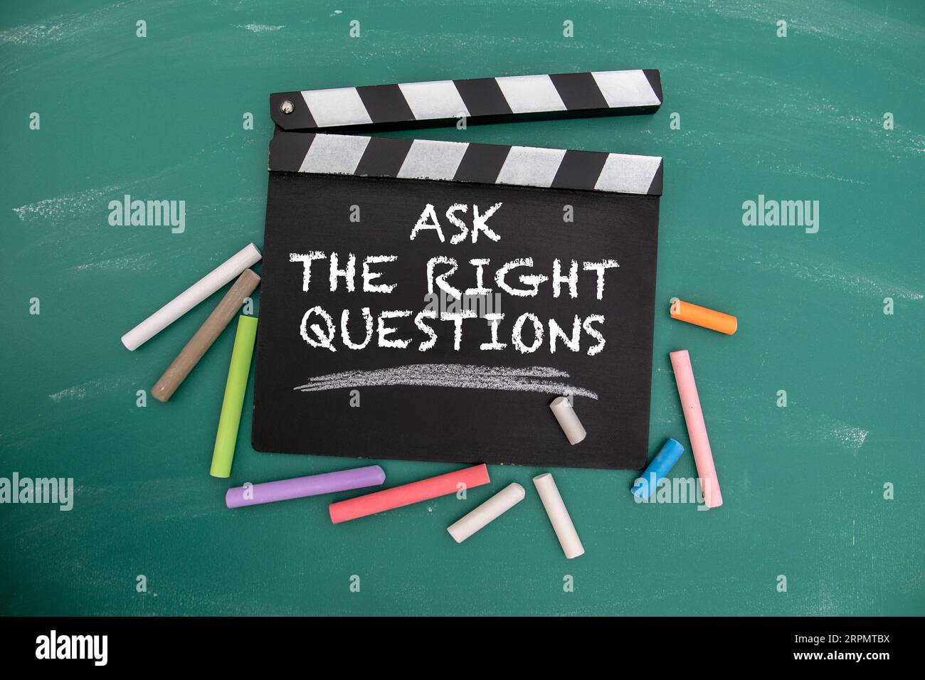 Ask The Right Questions. Black movie clapper with chalk pieces on a ...