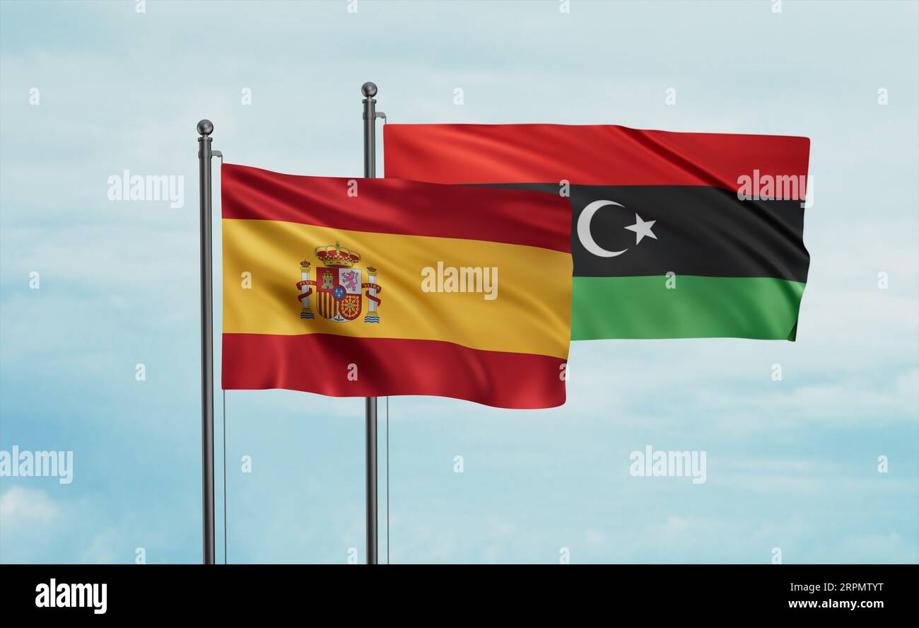 Libya and Spain flag waving together in the wind on blue sky, two ...