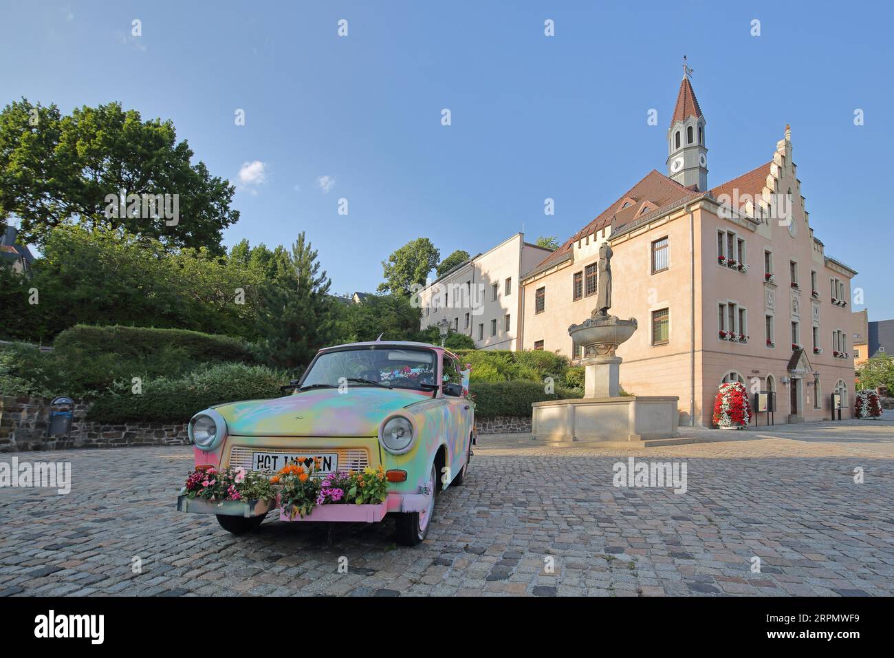 Colourful Trabant with flower decoration, ornamental fountain and town ...