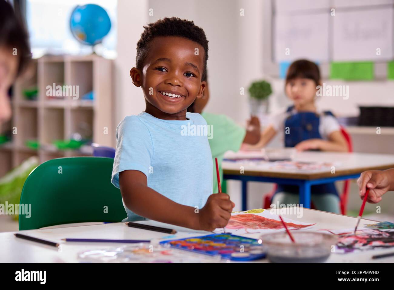 Classroom Portrait Of Smiling Male Elementary School Pupil In Art Class ...