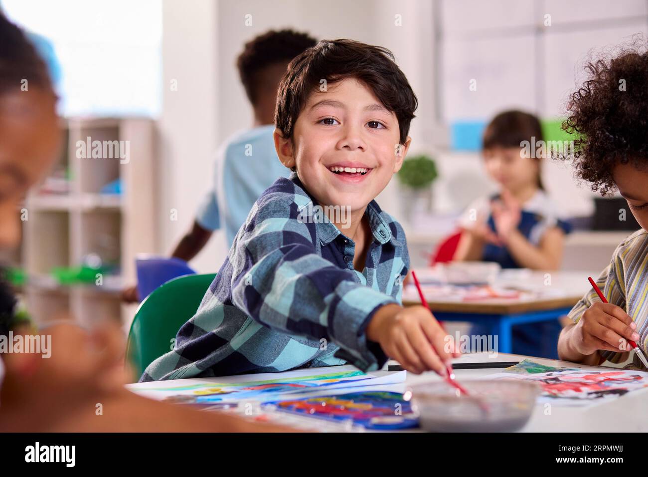 Classroom Portrait Of Smiling Male Elementary School Pupil In Art Class ...
