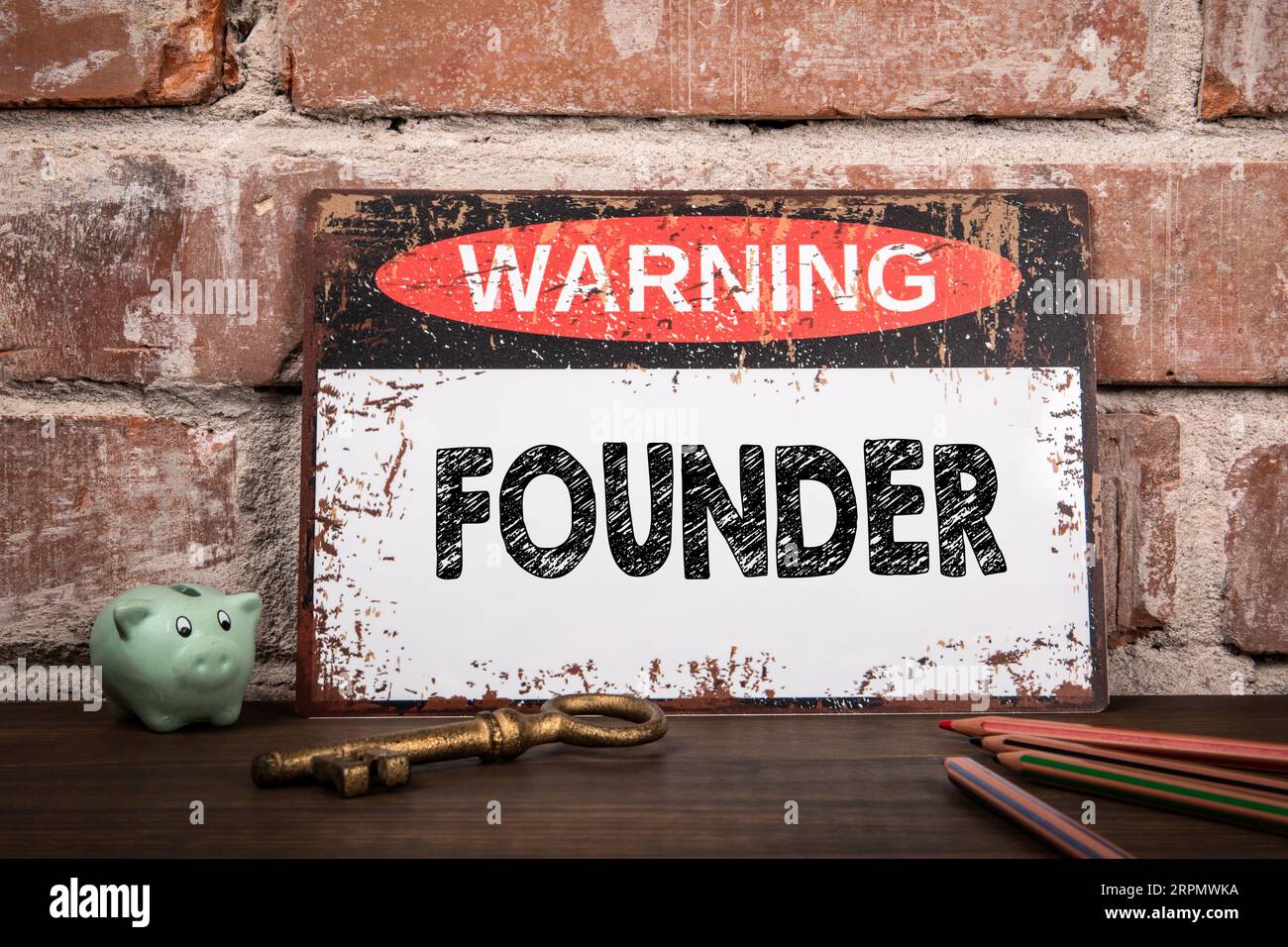 Founder. warning sign with text on wooden office desk Stock Photo - Alamy