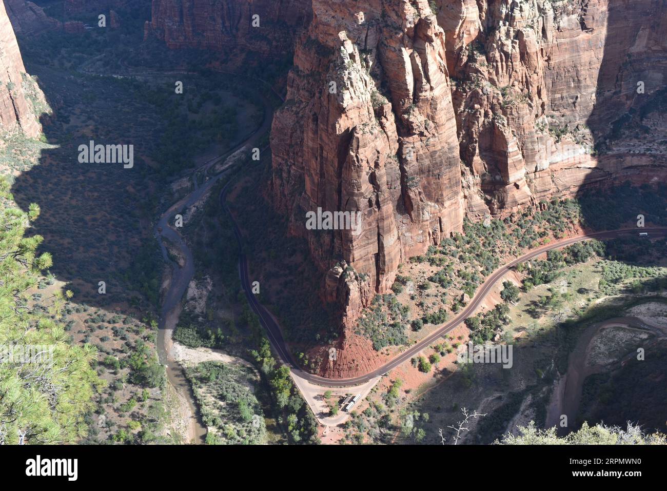 A scenic winding mountain road stretching through a lush green ...